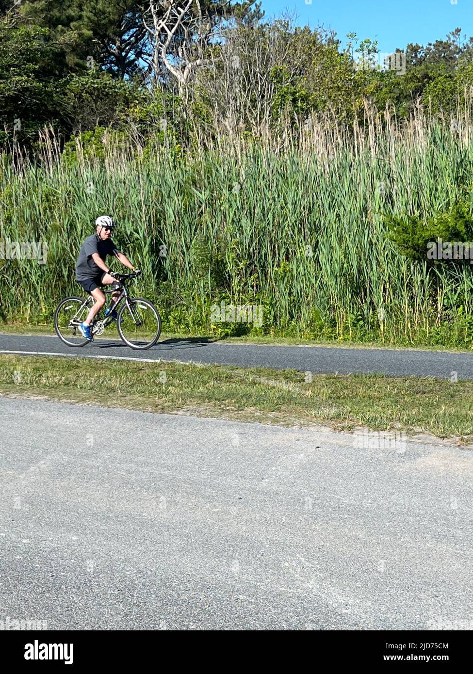 United States President Joe Biden rides his bike as he spends his ...