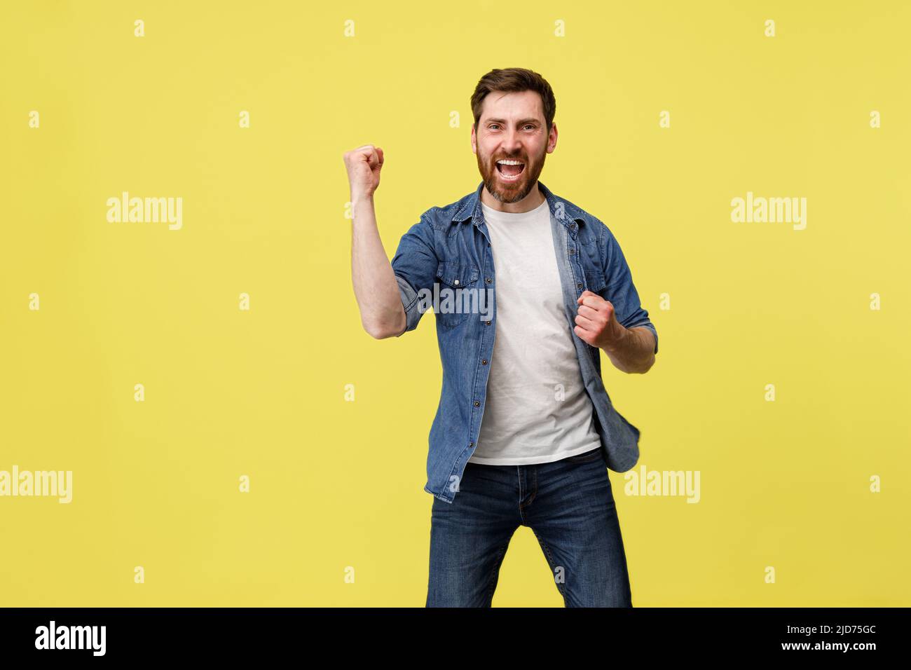 Excited happy man raise her hand up doing winner gesture clenching fist ...