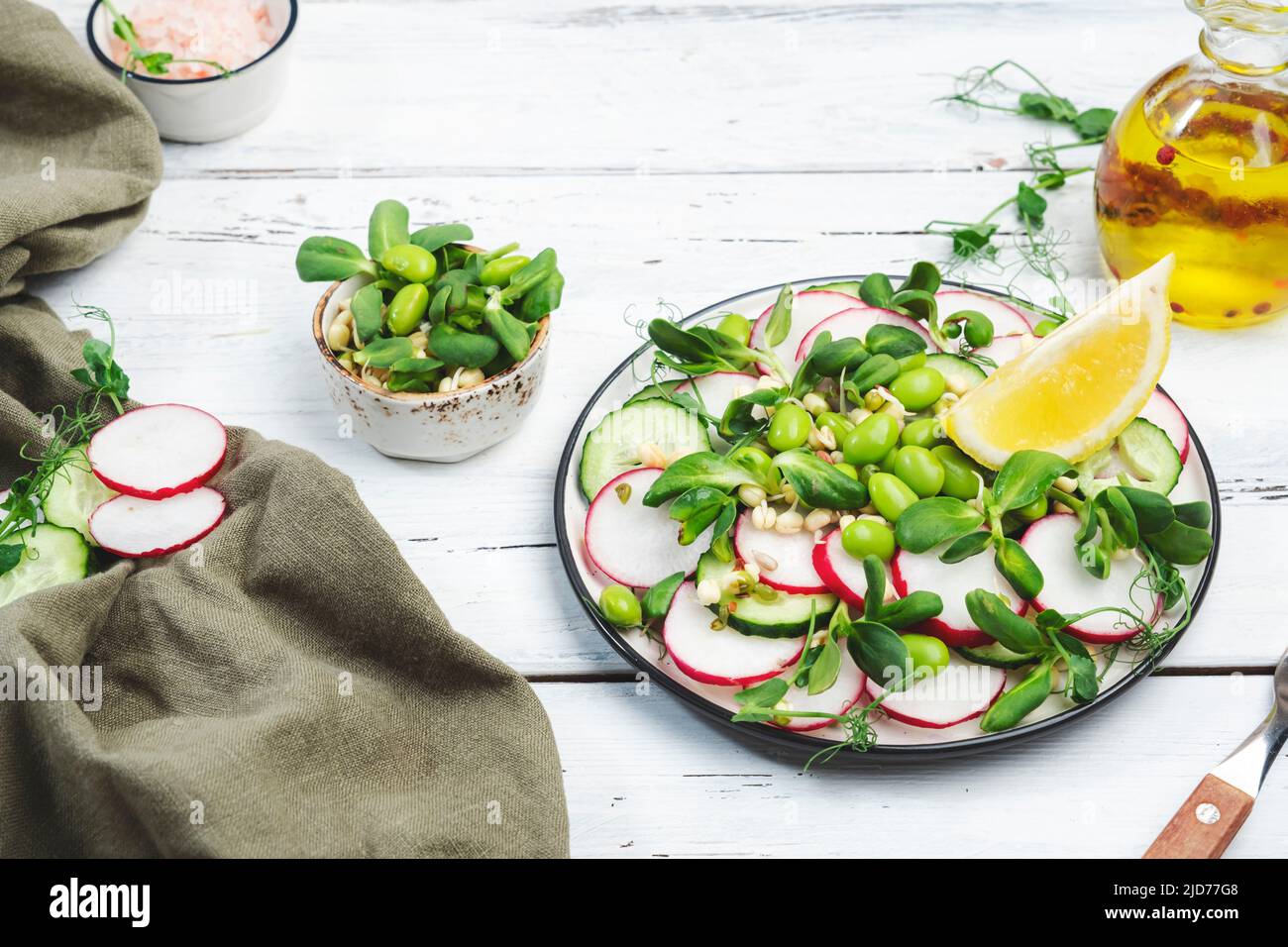 Fresh vegan salad with radish, cucumber, green pea, sunflower and soy ...