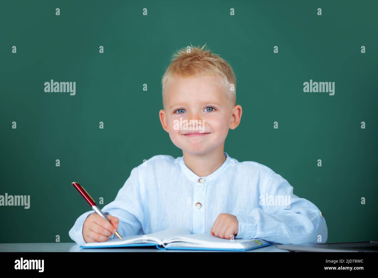 Kid writing in class. School child student learning in class, study ...