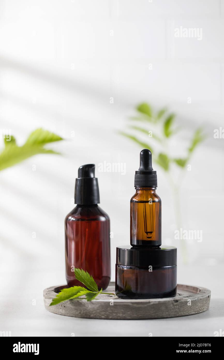 Three different brown glass bottles with eco-friendly organic cosmetic ...