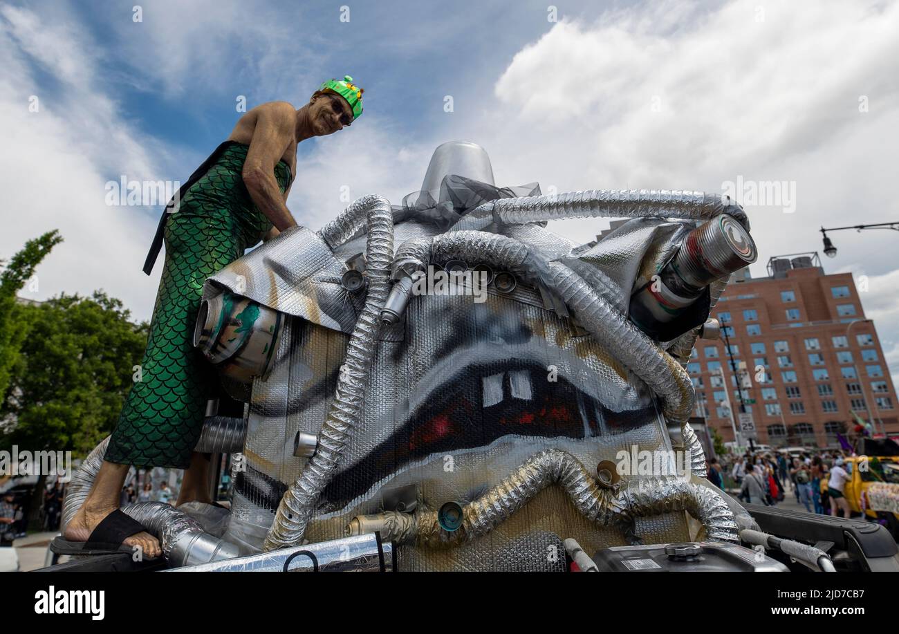 A man dressed as King Neptune works on a parade float. The Coney Island ...