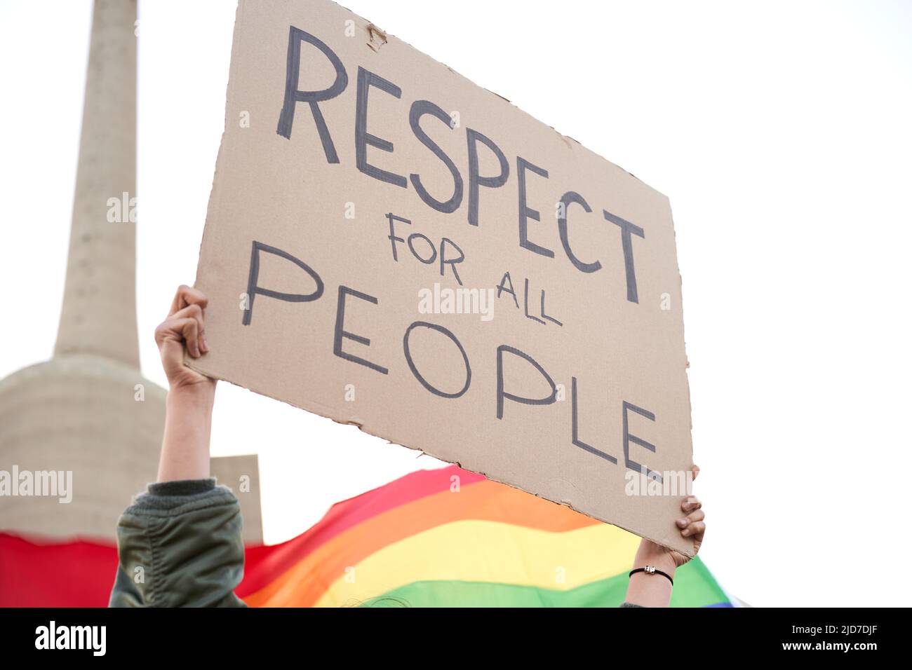 A person holding a banner saying Respect For All People at a gay pride ...