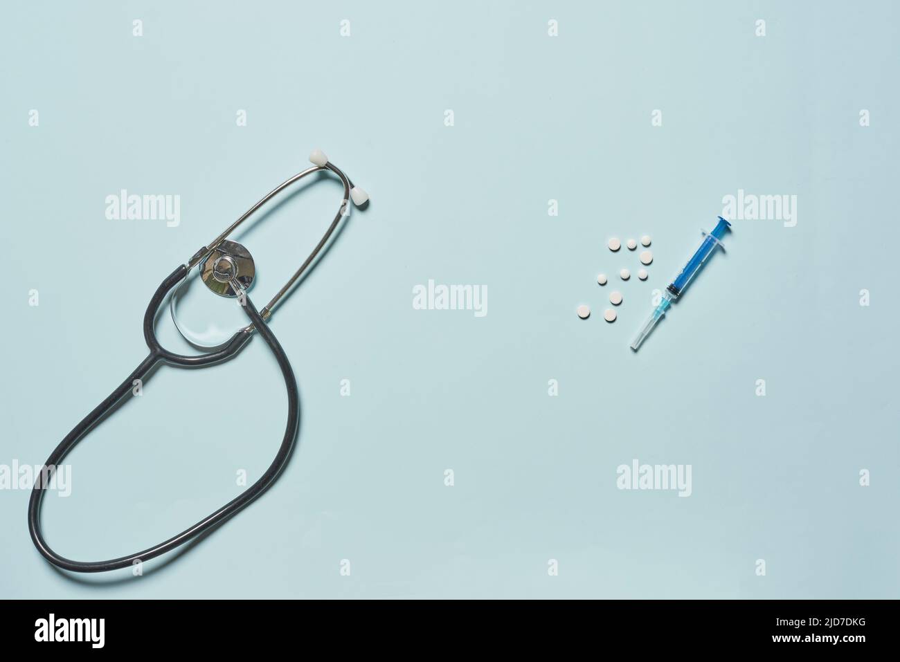 A disposable syringe for injection, stethoscopen and white round ...