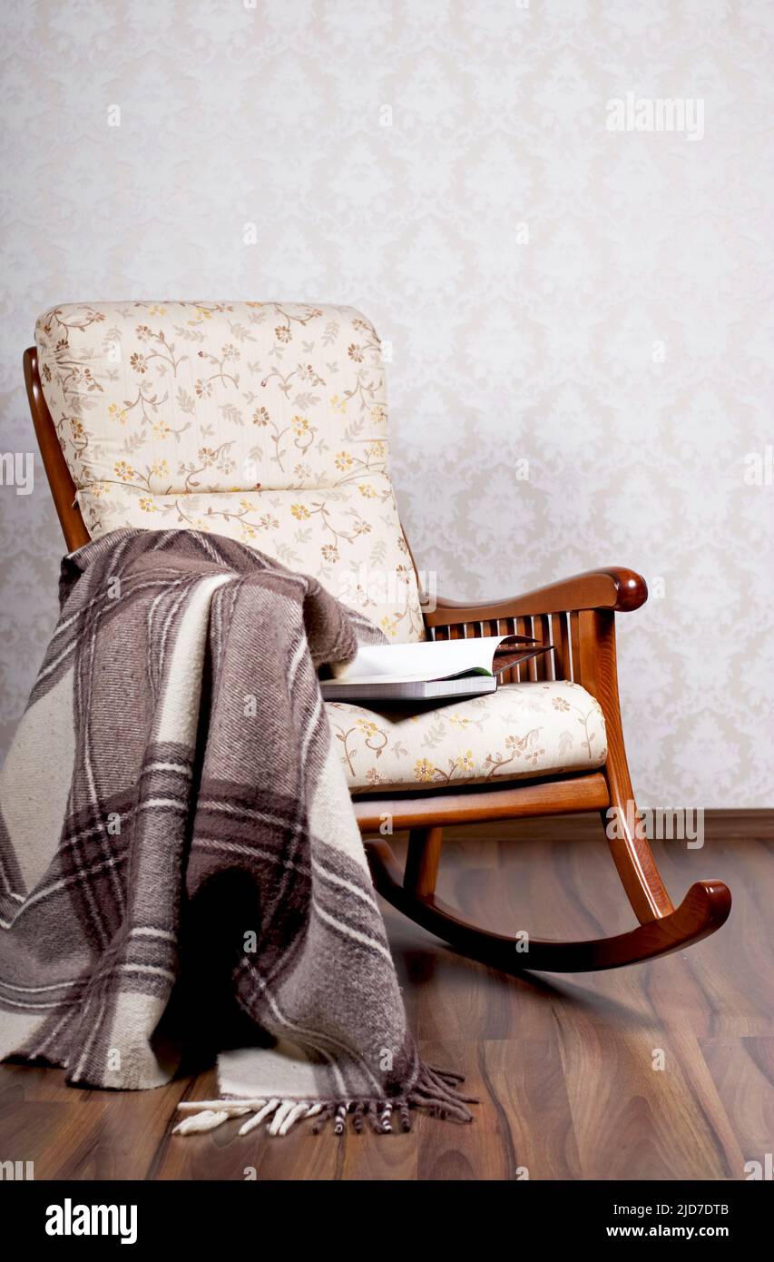 modern rocking chair near a light wall Stock Photo - Alamy