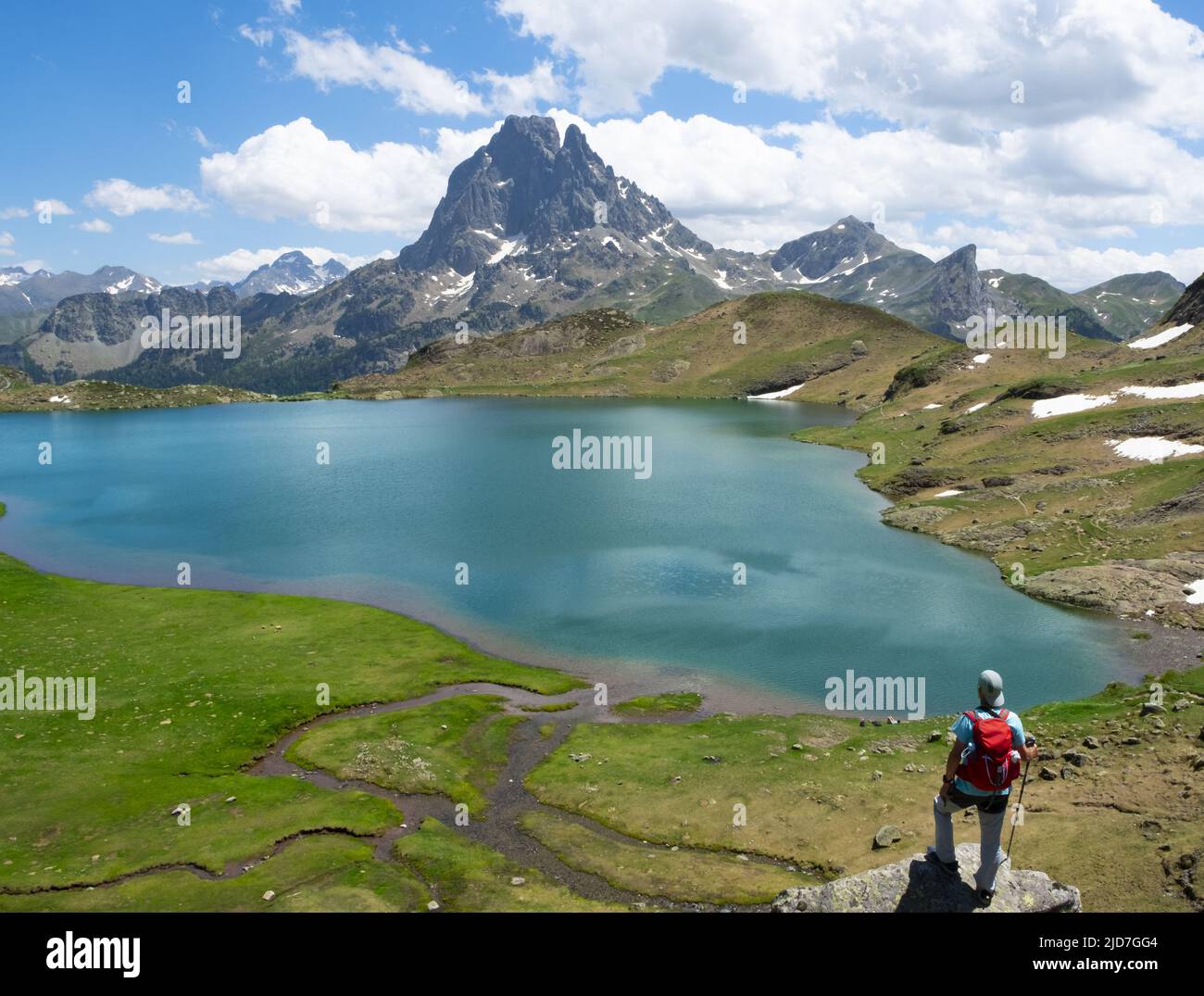 Mountaineer on Lake Gentau with the Midi d Ossau in the background ...