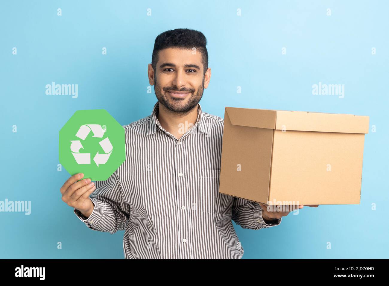 Responsible self confident man holding green recycling sign in hand and ...