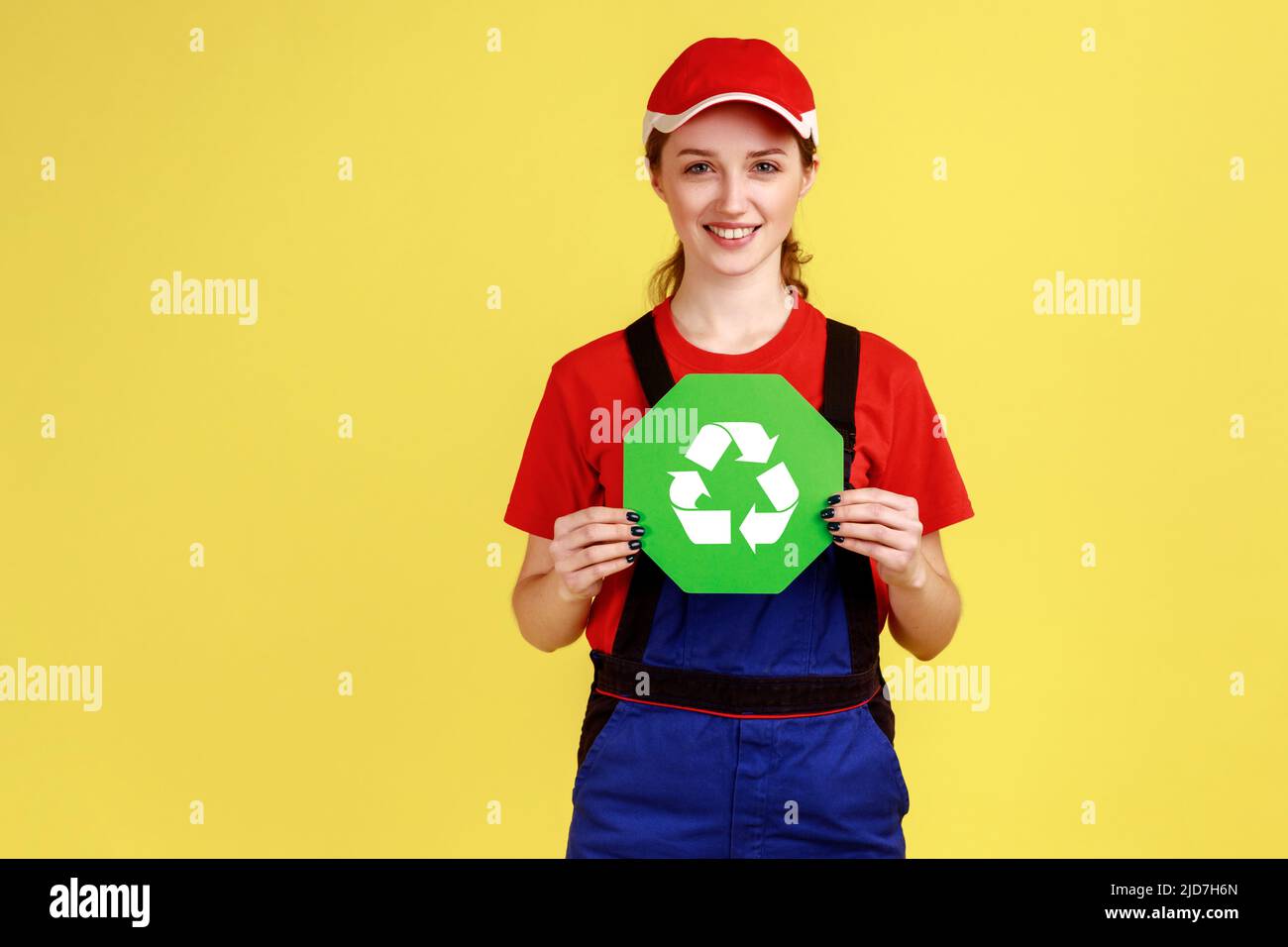 Portrait of smiling happy worker woman standing and holding recycling ...