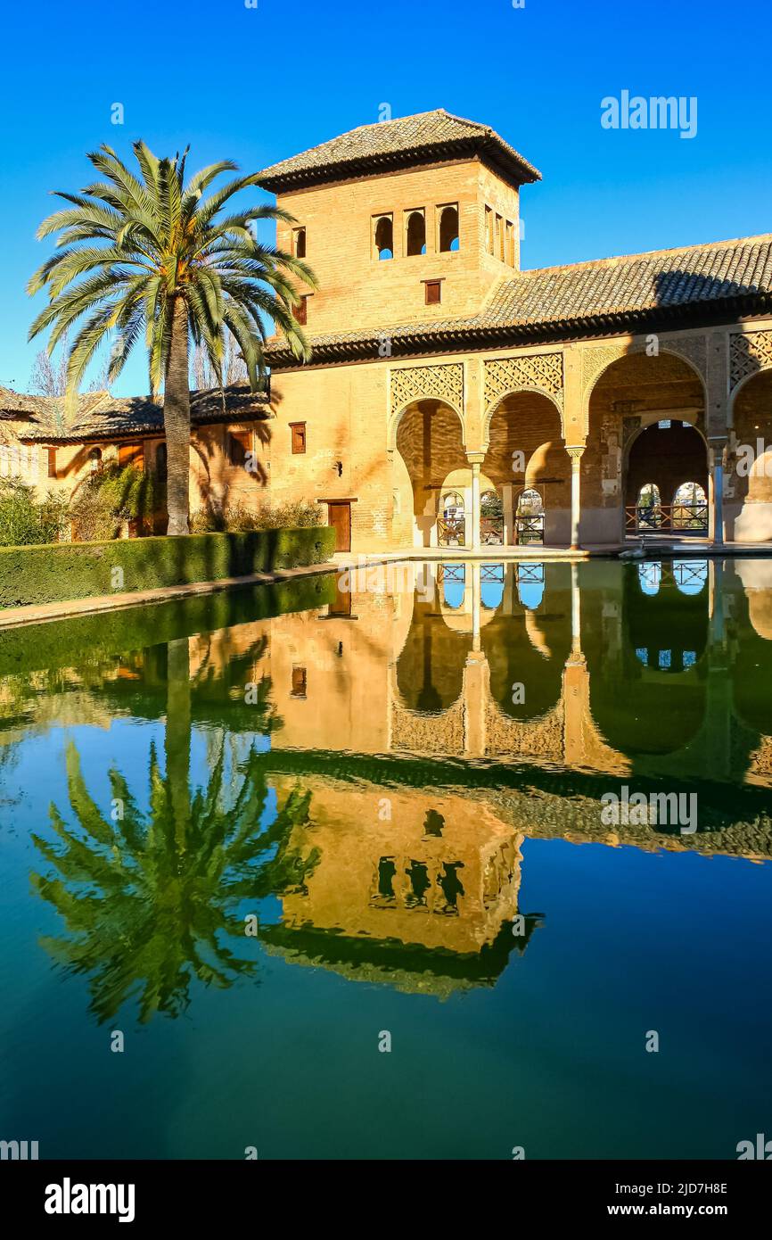 Alhambra Palace with its arches and reflection of buildings in the ...