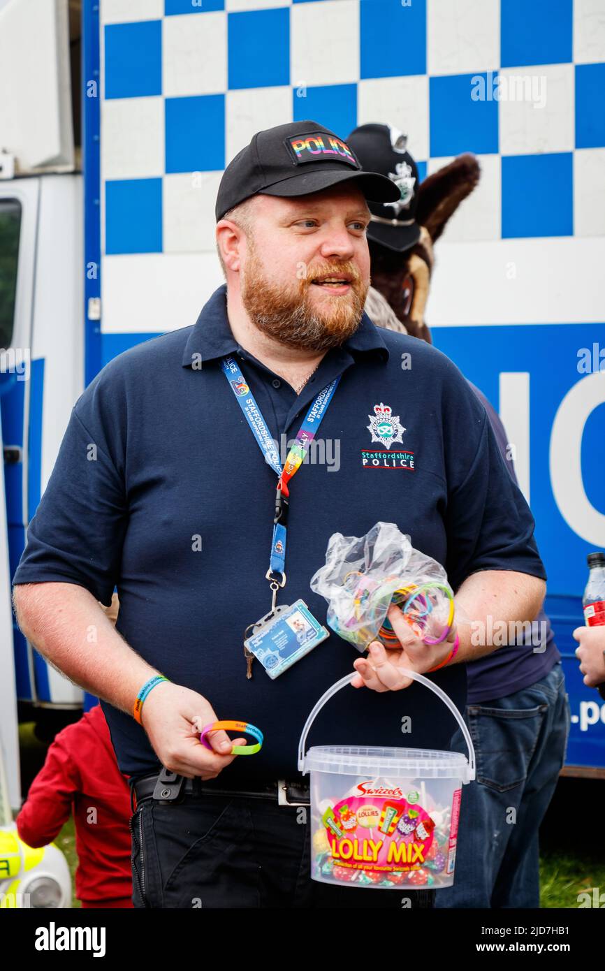 police officer holding tub of sweets Stoke Gay Pride event in Hanley ...