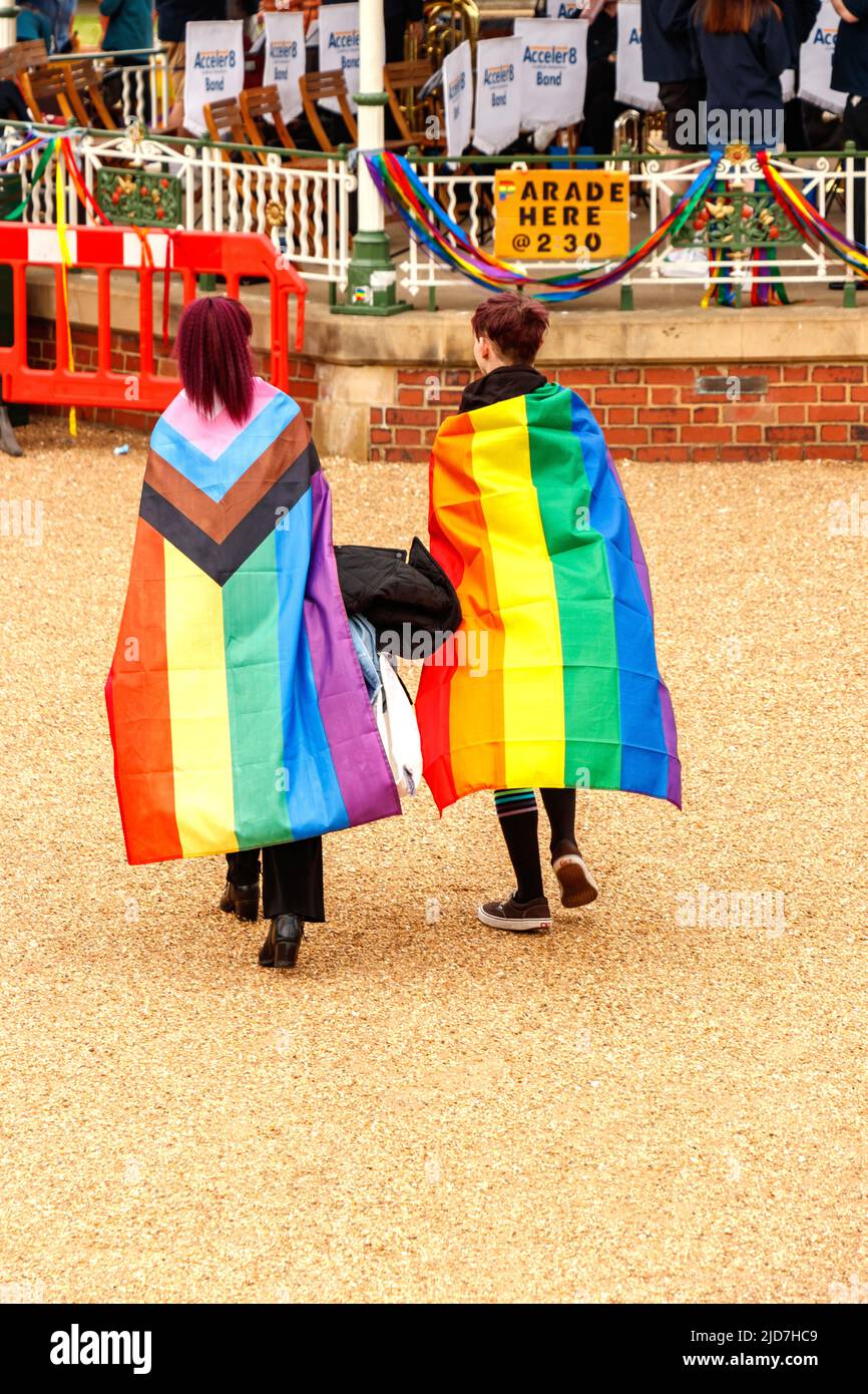 teenagers with rainbow flags around their shoulders at Stoke Gay Pride ...