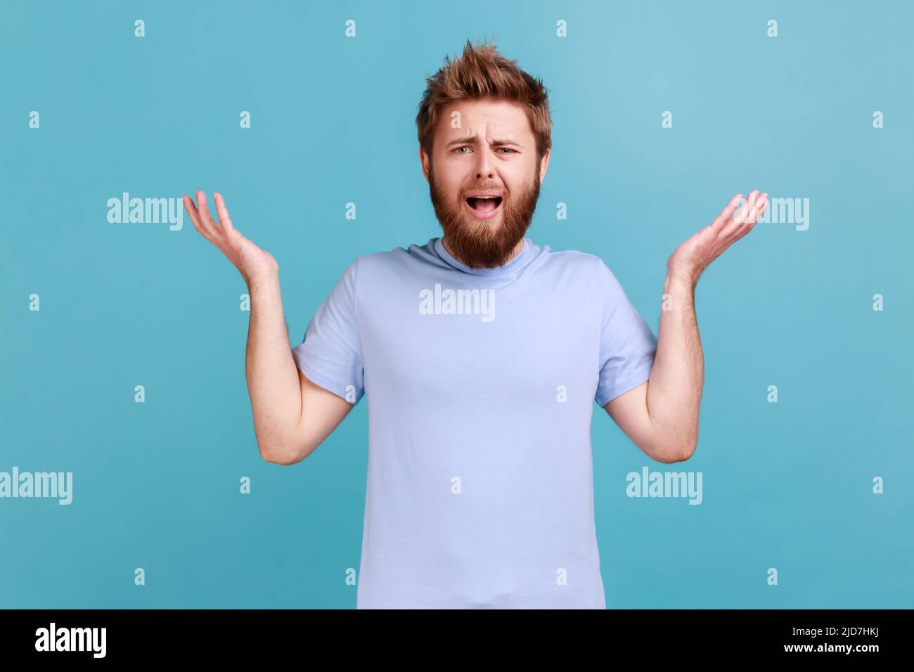What do you want. Portrait of annoyed frustrated bearded man standing ...