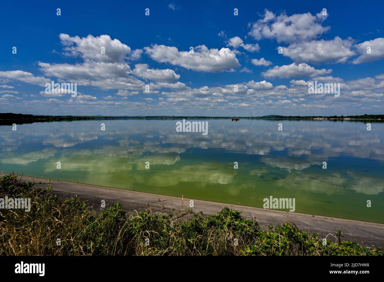 Blue sky with white clouds reflecting on the water Stock Photo - Alamy