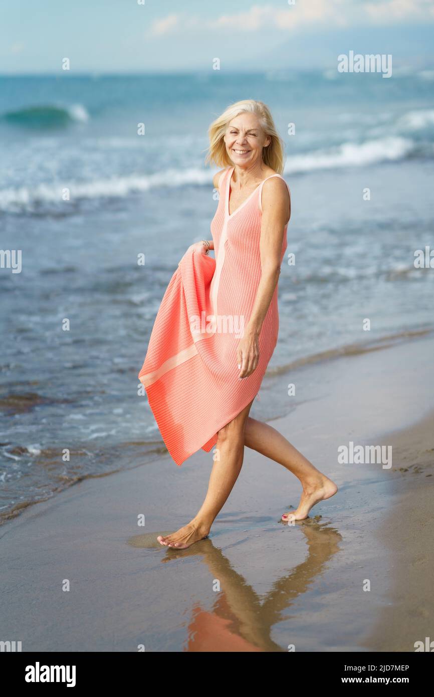 Elderly female enjoying her retirement at a seaside retreat. Senior ...