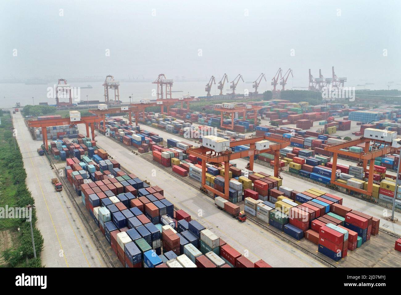 CHANGZHOU, CHINA - JUNE 19, 2022 - Trucks load and unload containers at ...