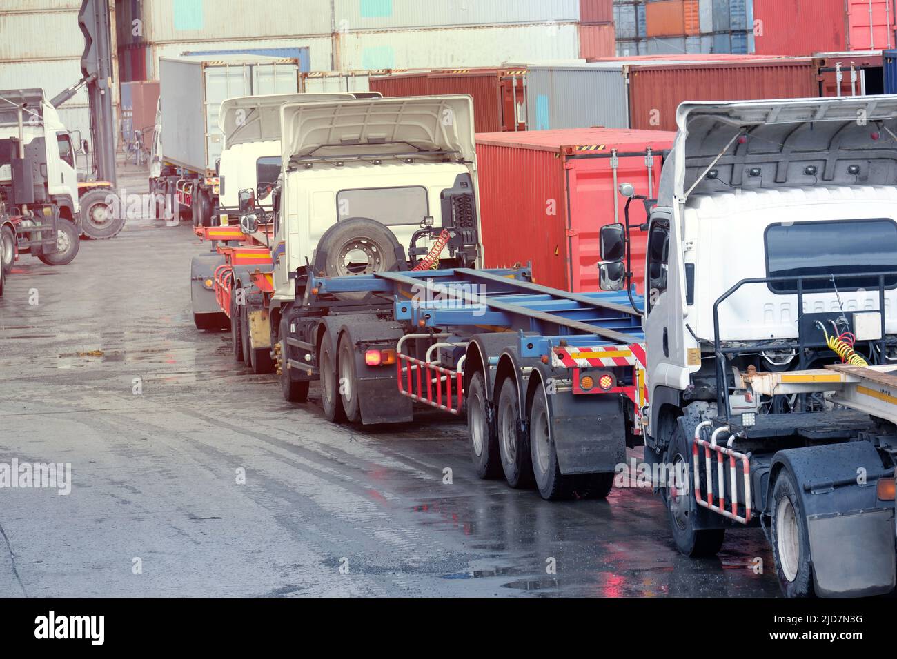 Multiple trucks in the port Stock Photo - Alamy