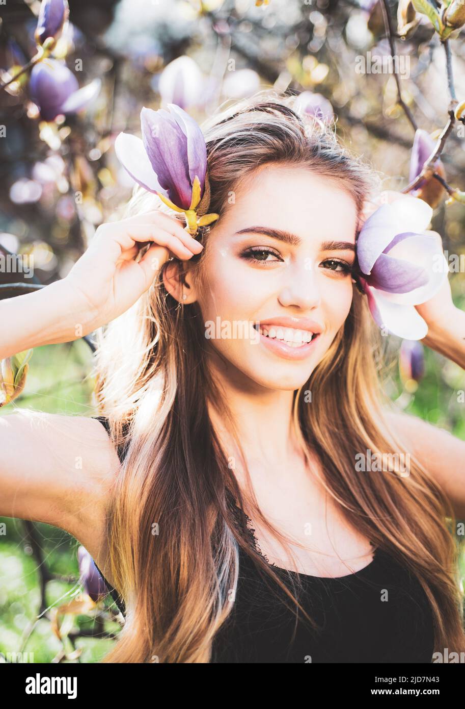 Beautiful spring girl in pink flowers in summer blossom park. Woman in ...