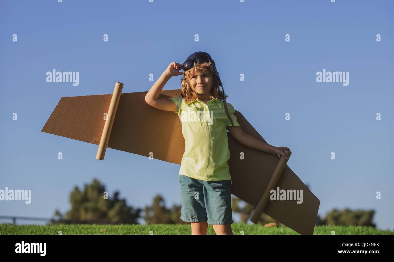 Child to be pilot. Kid with paper wings flying. Summer vacation and ...