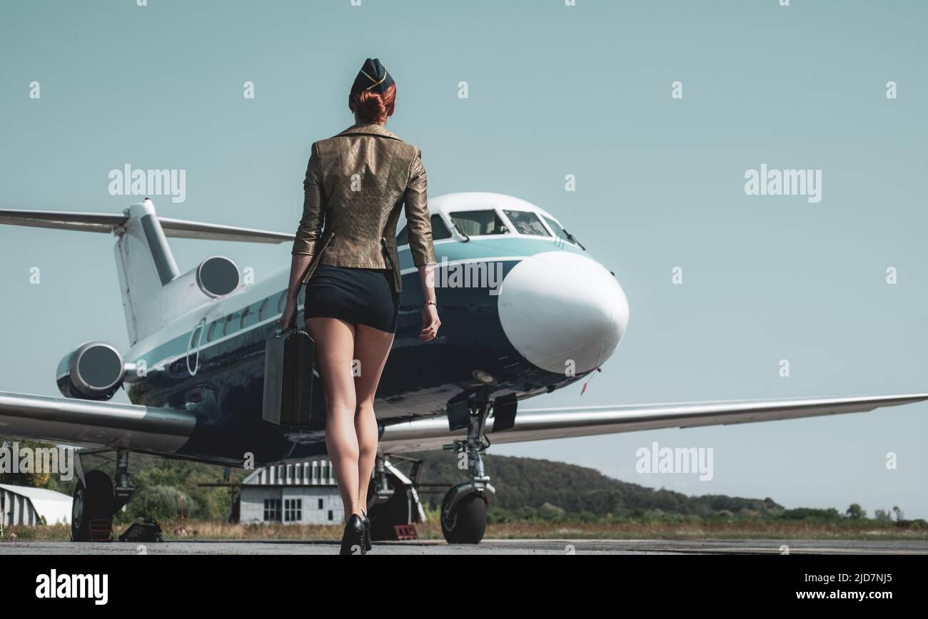 Stewardess in blue uniform - back view. Pretty female flight attendant ...