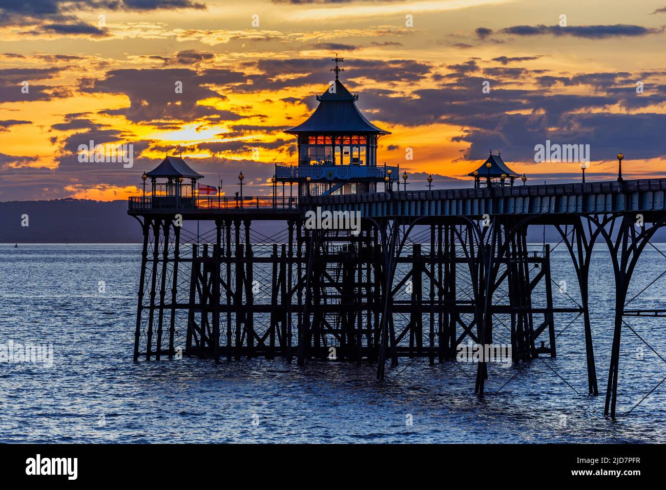 The setting sun lighting up the cloud cover on the horizon Stock Photo ...