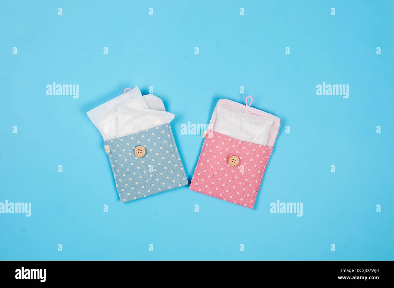 women's sanitary pads in blue and pink handbag on a blue background ...