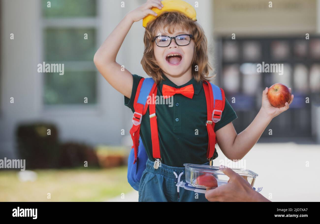 Funny nerd. Funny pupil of primary school. Little schoolboy eating ...