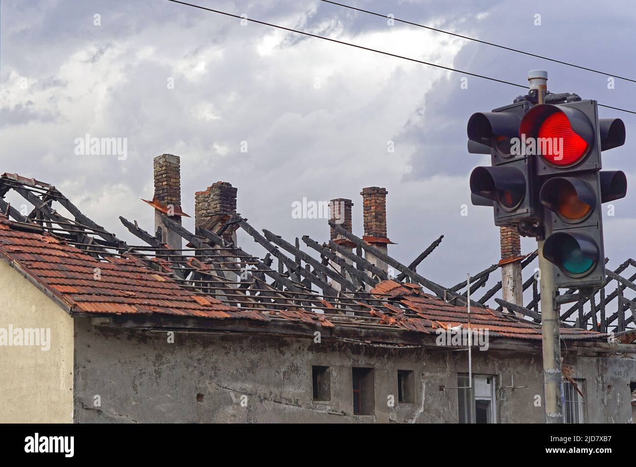 Burned roof at house fire damage danger red traffic light Stock Photo ...