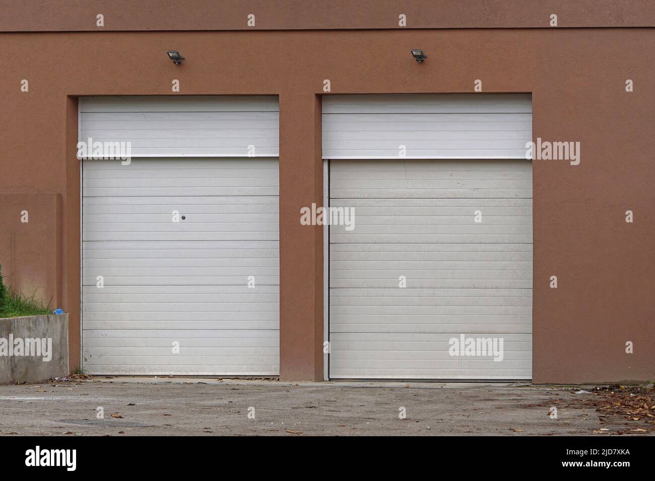 Two large white garage doors at house building Stock Photo - Alamy