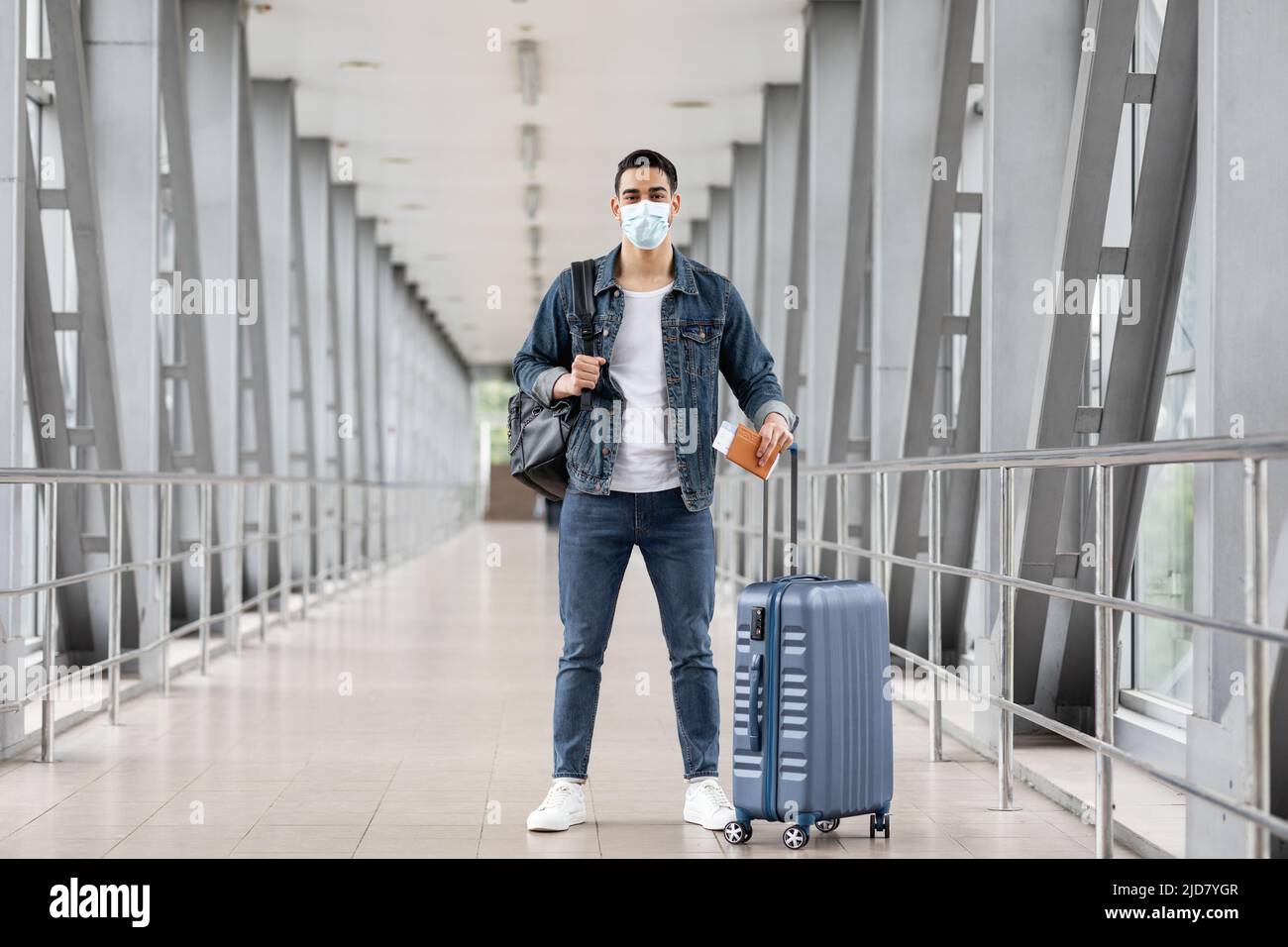 Young Arab Man Wearing Medical Face Mask Standing With Luggage In ...