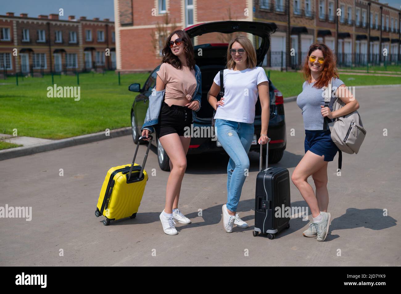 Three friends are going to travel by car. Summer vacation Stock Photo ...