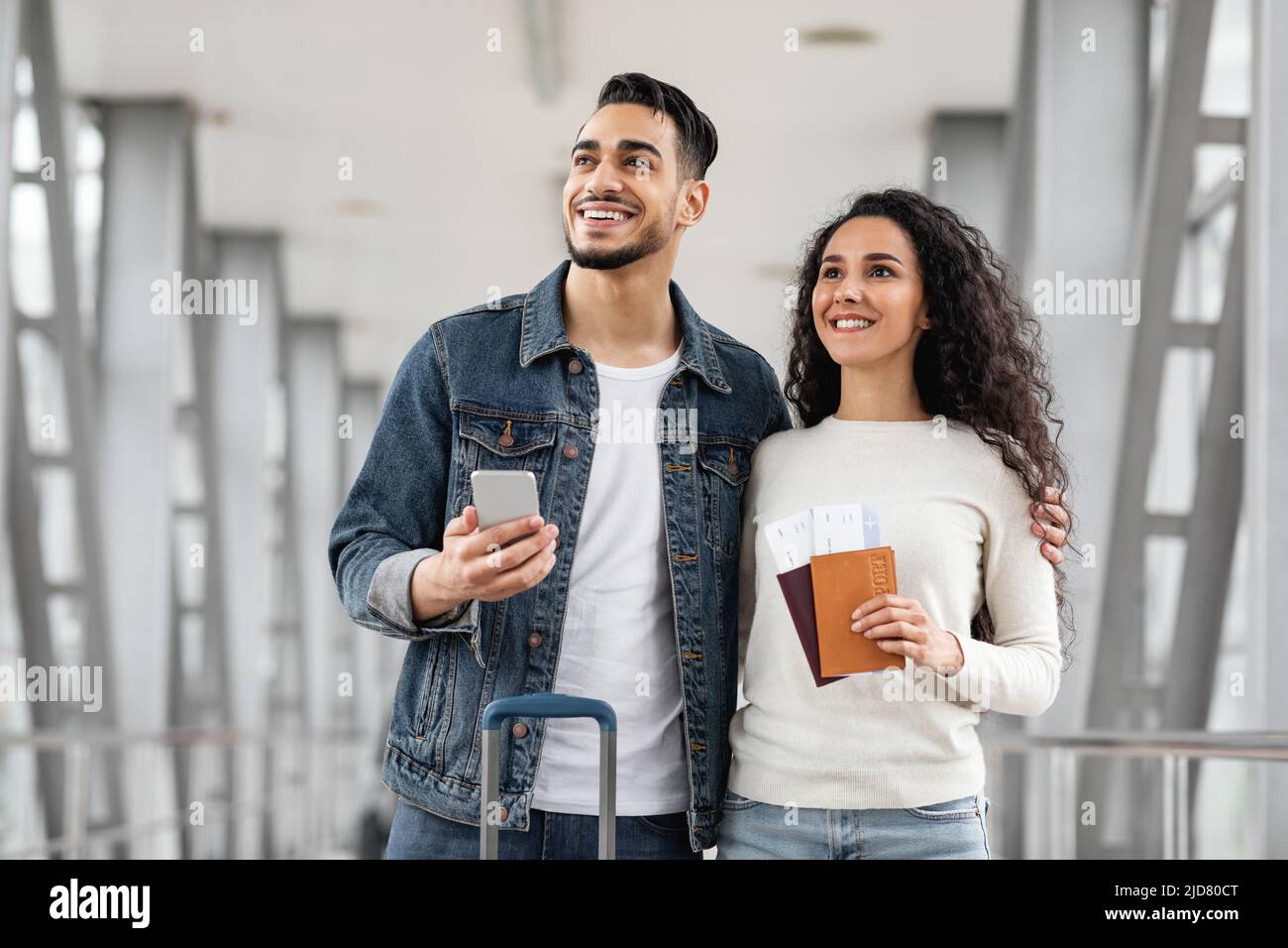Millennial Arab Couple Standing At Airport Together And Looking Away ...