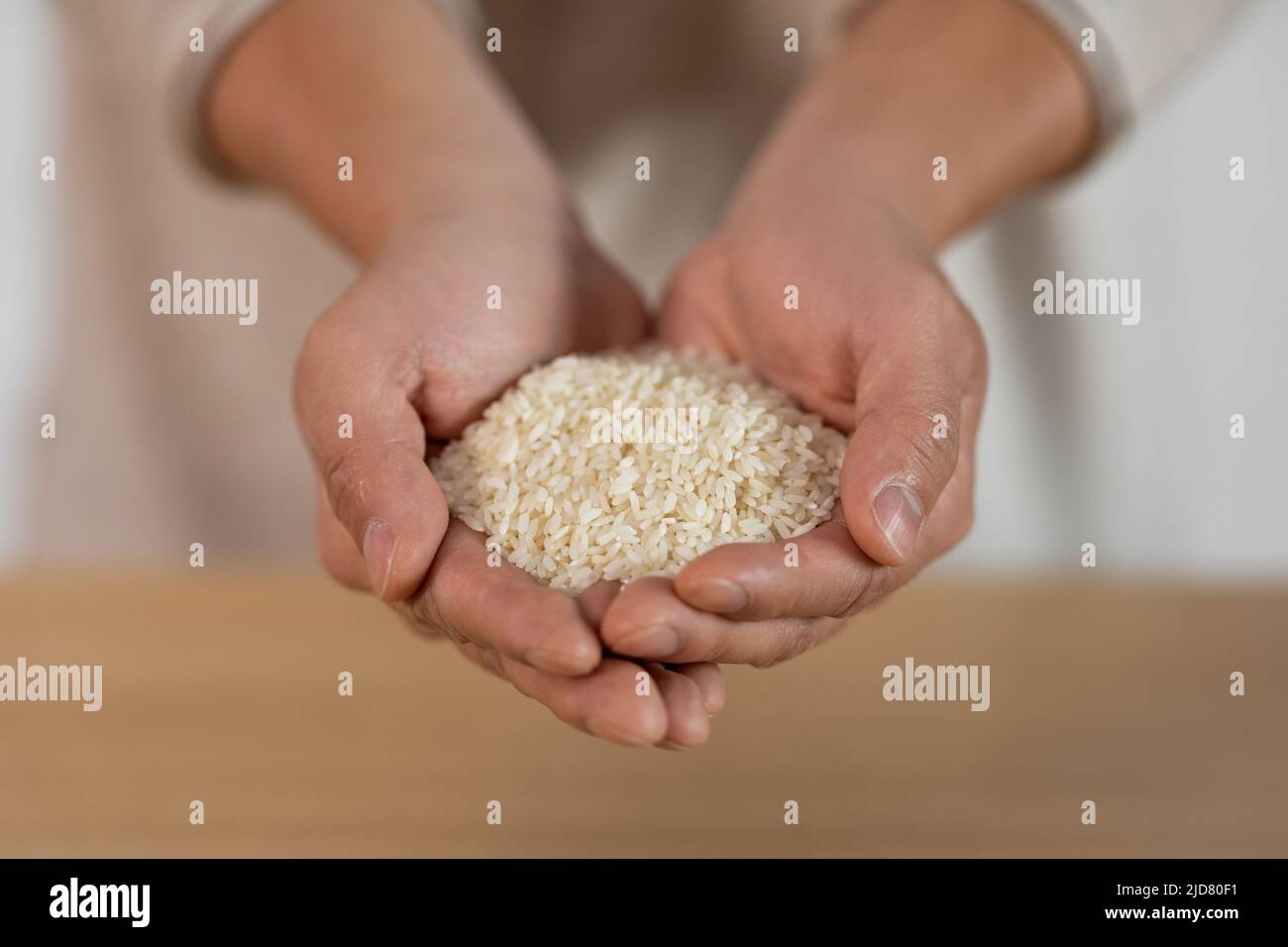 Unrecognizable person hands with handful of rice Stock Photo - Alamy