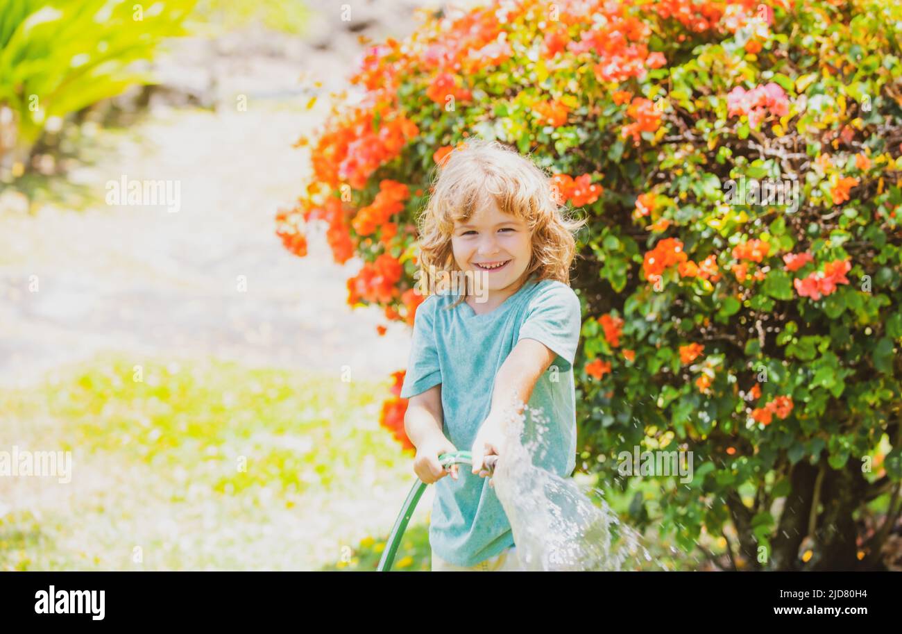 Cute boy watering plants in the garden at summer day. Child with garden ...