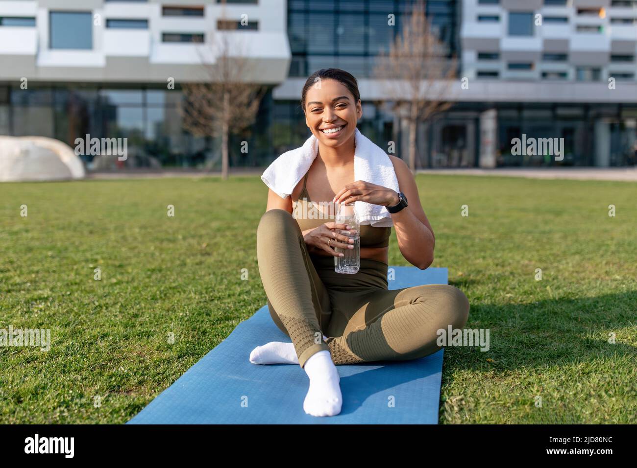 Athletic Young Black Lady In Sportswear Sitting On Sports Mat With