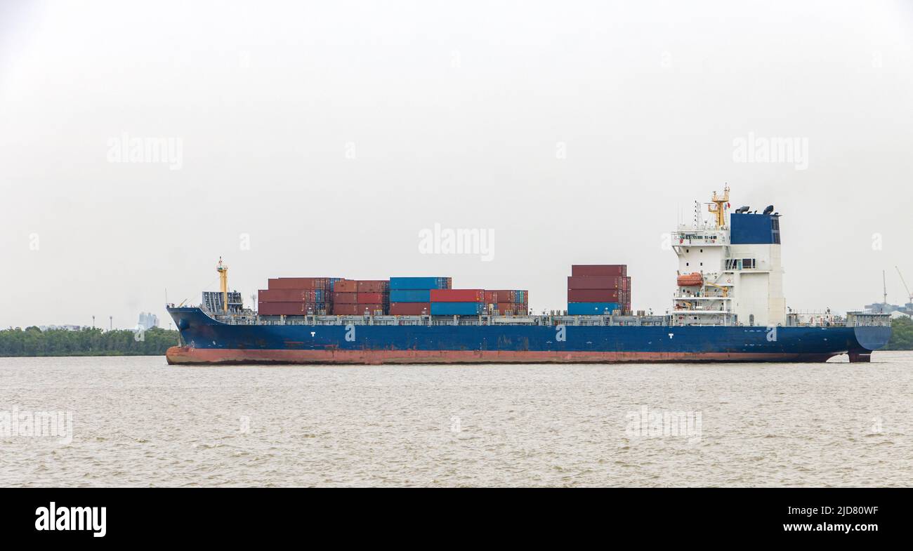 The Container Ship loaded of containers sail beside a seashore Stock ...
