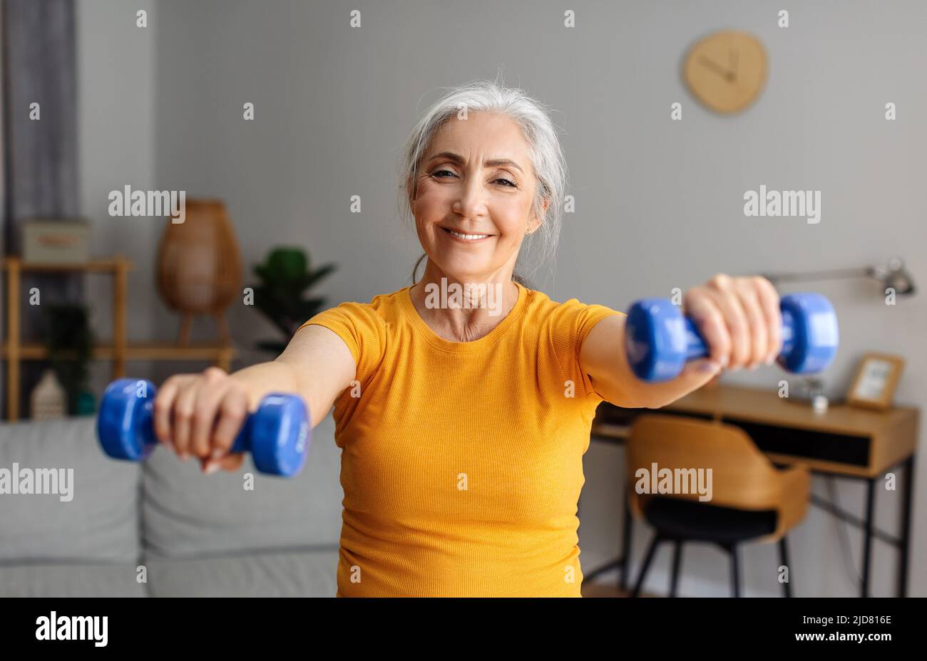 Health care, sport and active lifestyle. Happy senior woman doing ...
