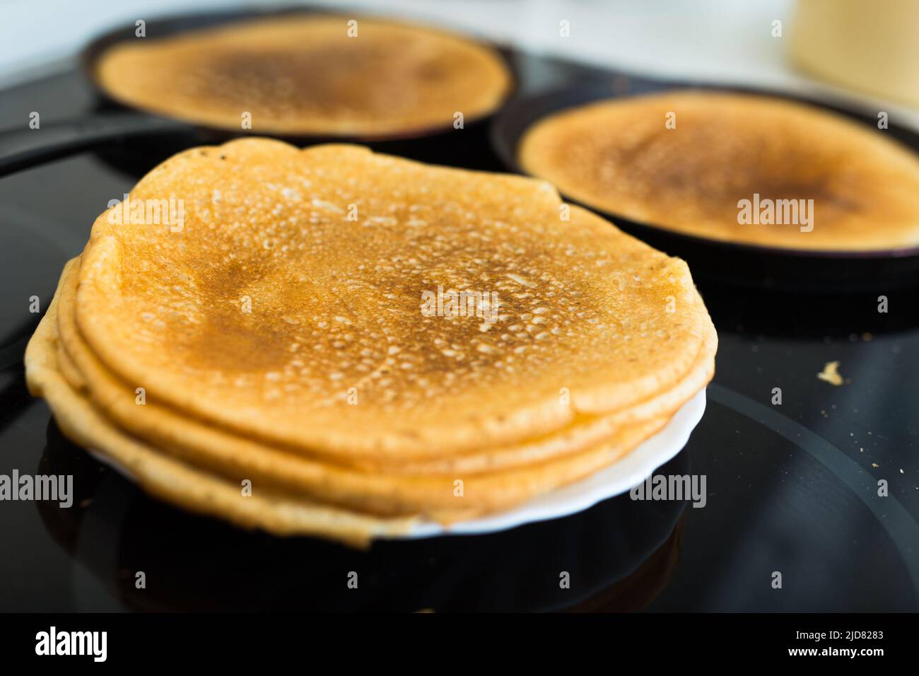 cooking traditional pancakes from wheat flour in the kitchen Stock ...