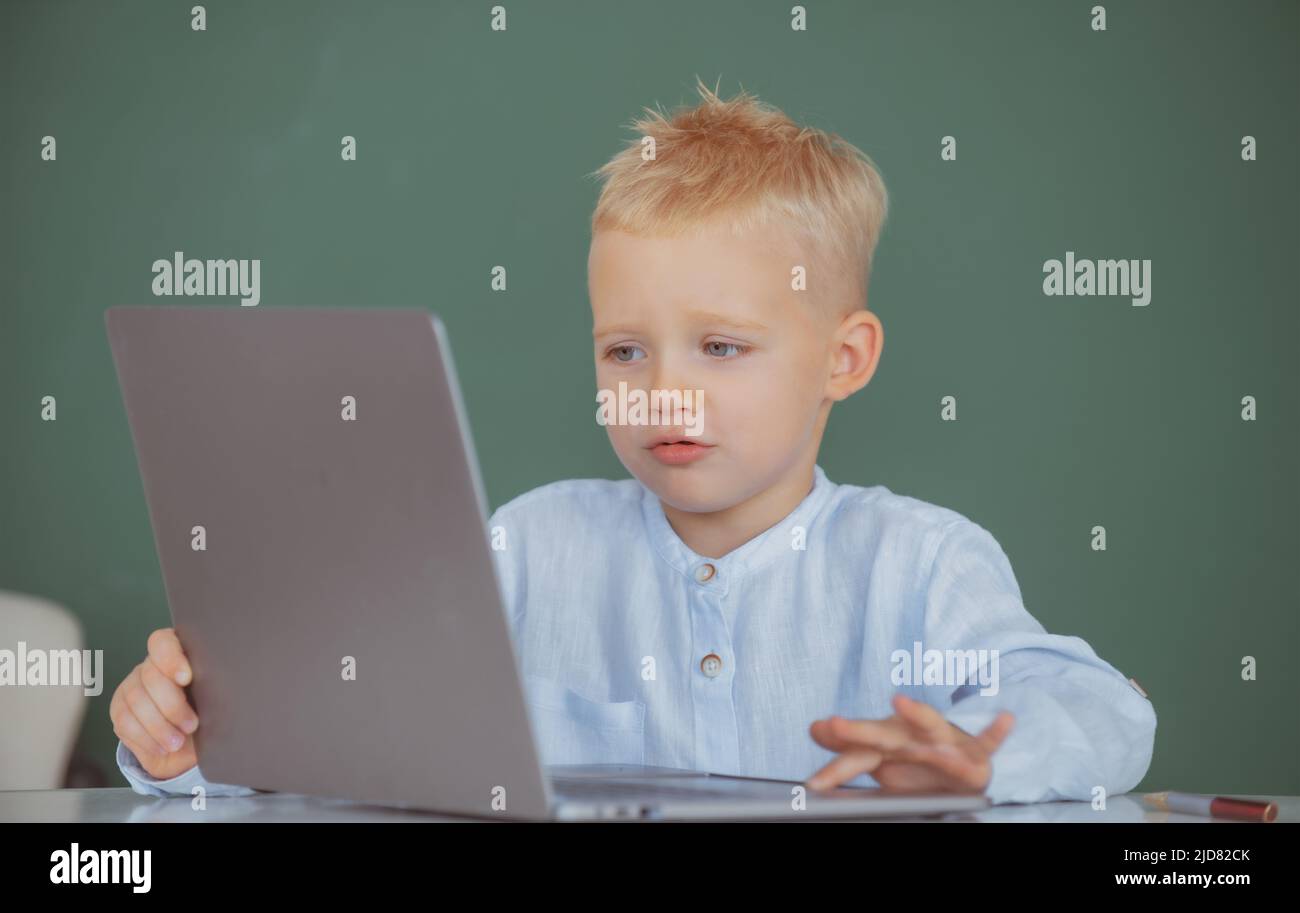 Child using gadgets to study. Computer education for kids. Little funny ...