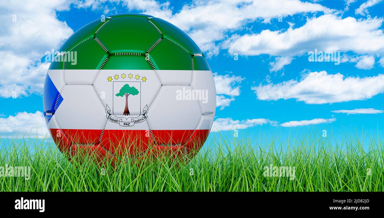 Soccer ball with Equatoguinean Guinea flag on the green grass against ...