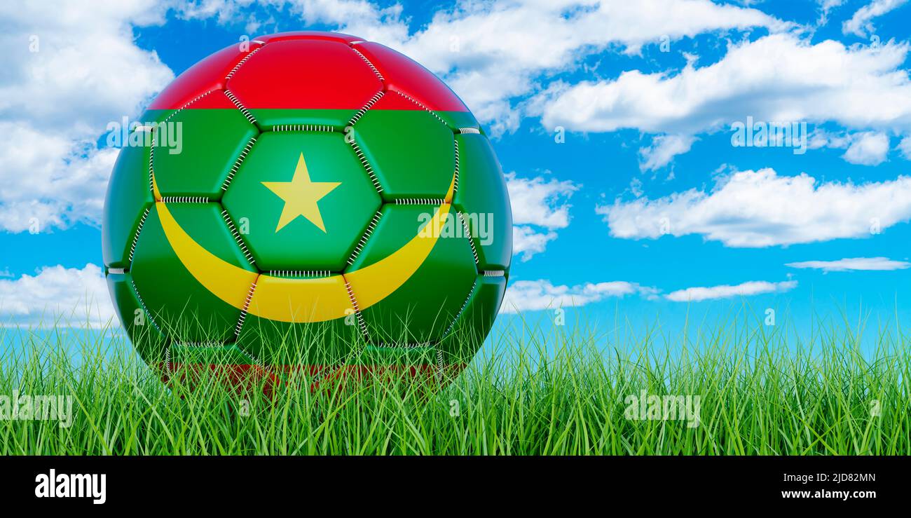 Soccer ball with Mauritanian flag on the green grass against blue sky ...