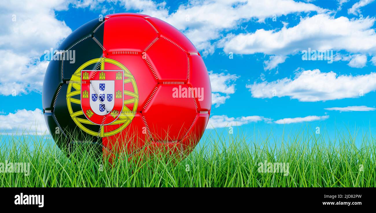 Soccer ball with Portuguese flag on the green grass against blue sky ...