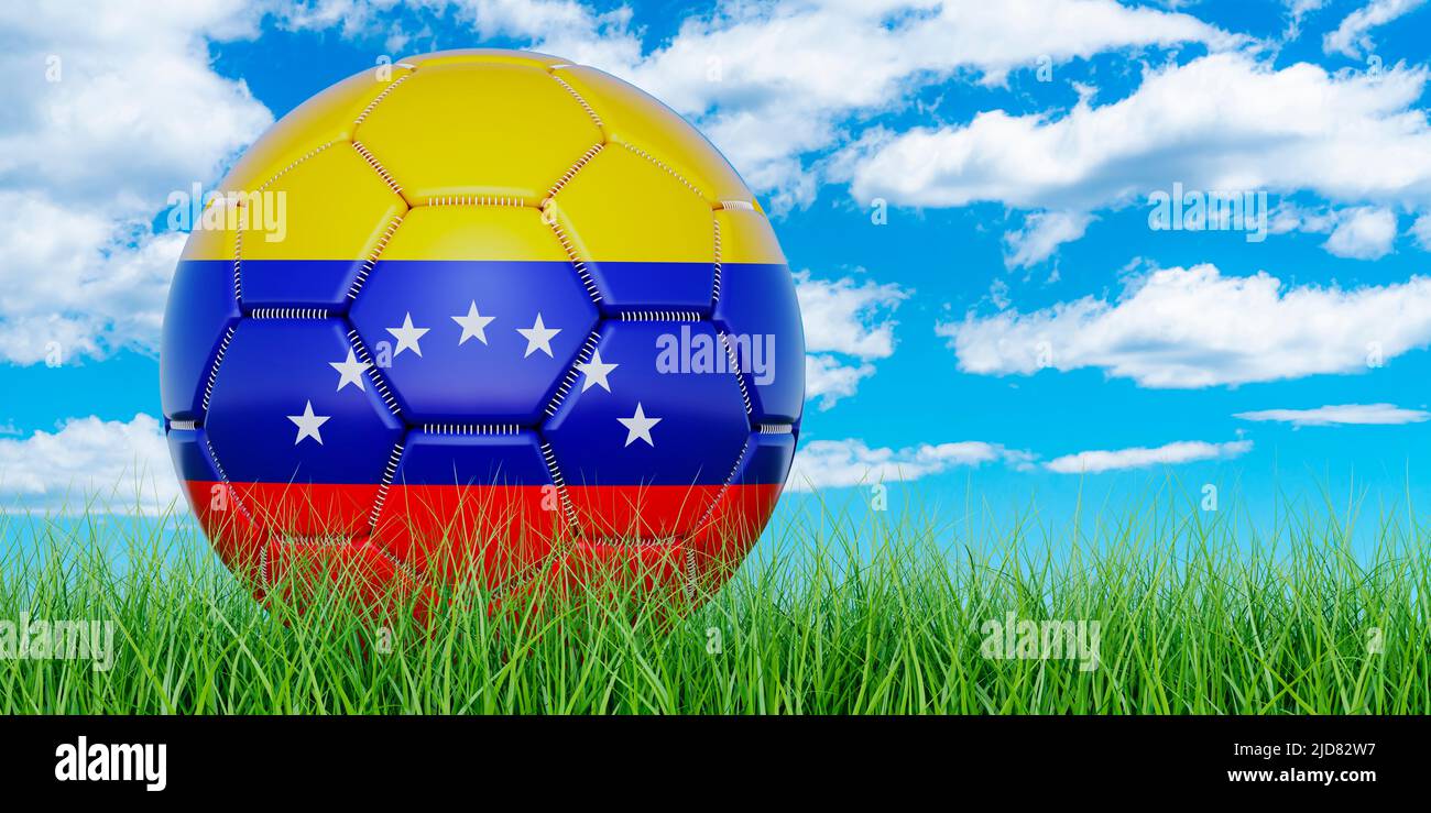 Soccer ball with Venezuelan flag on the green grass against blue sky ...