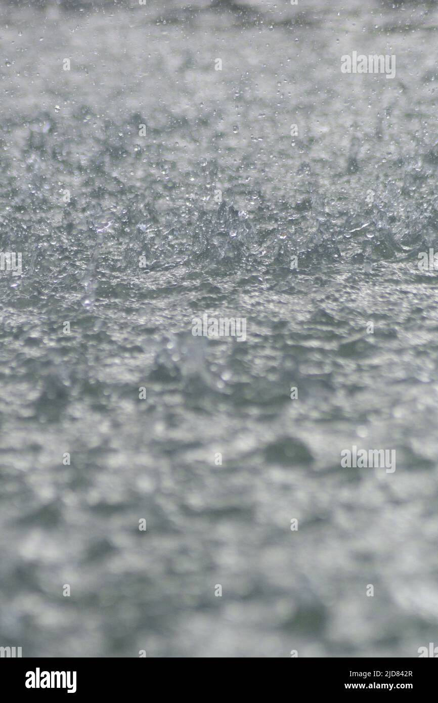 Water drops falling and splashing in a puddle with force Stock Photo ...