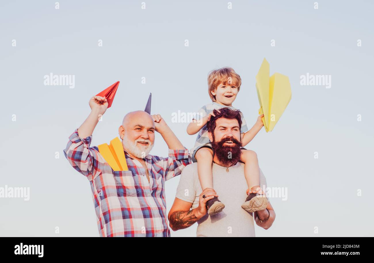 Happy smiling boy on shoulder dad looking at camera. Three different ...