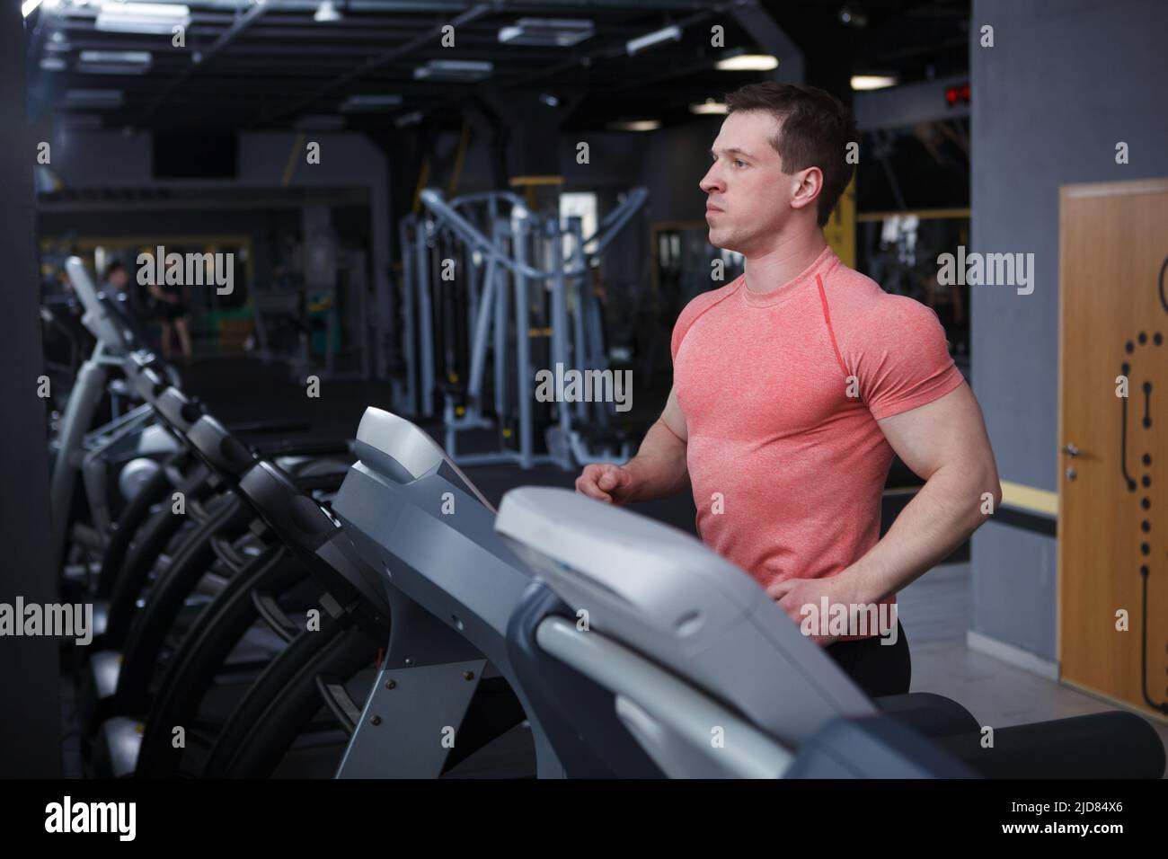 Muscular man running on a treadmill at the gym Stock Photo - Alamy