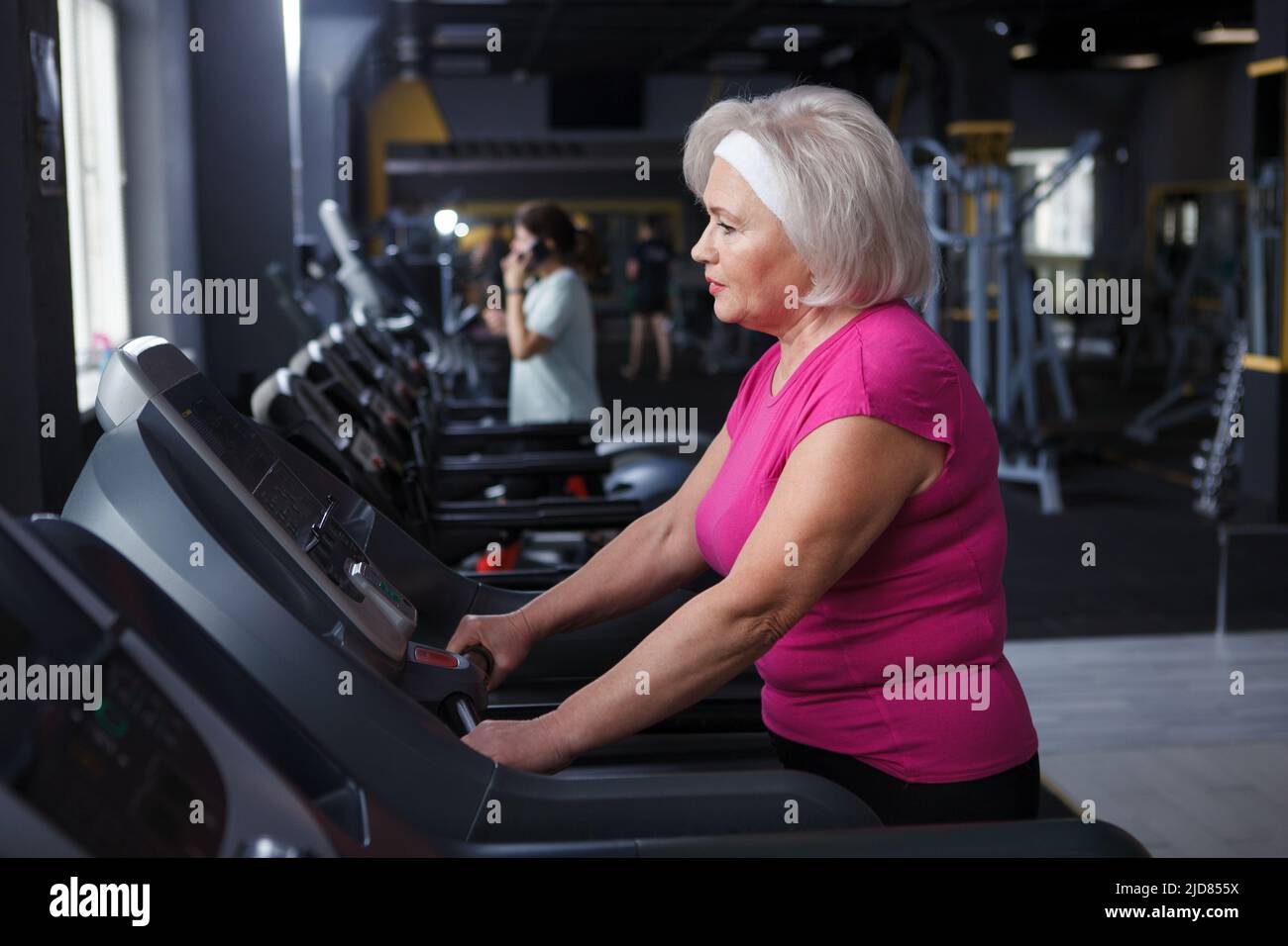 Senior woman running on treadmill hi-res stock photography and images ...