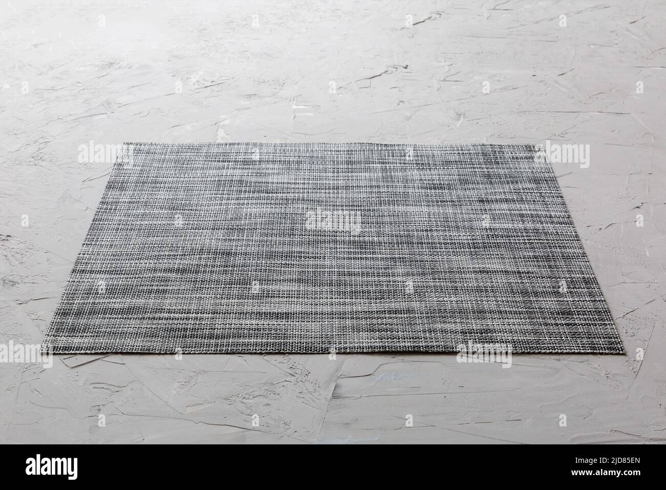Perspective view of grey tablecloth for food on cement background ...