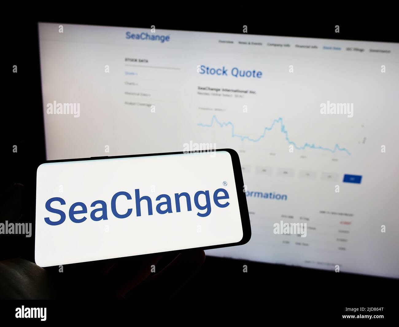 Person holding mobile phone with logo of American company SeaChange ...