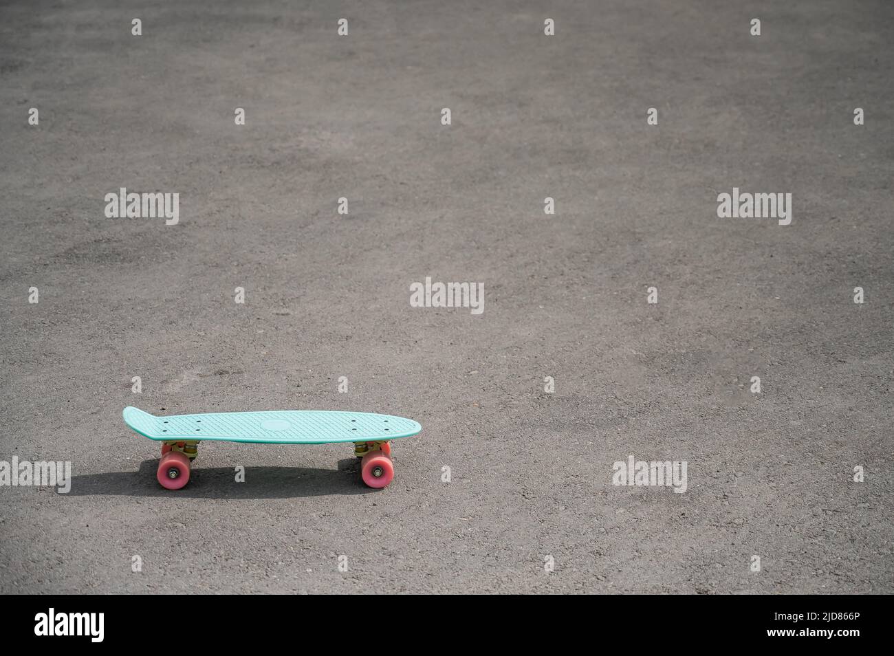 Blue penny board on the pavement. Copy space Stock Photo - Alamy