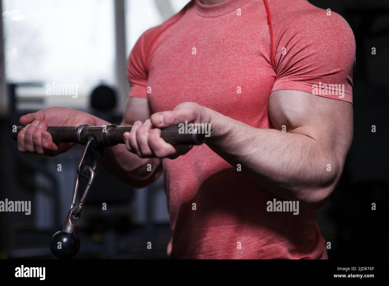 Cropped close up of ripped muscular arms of bodybuilder during gym ...